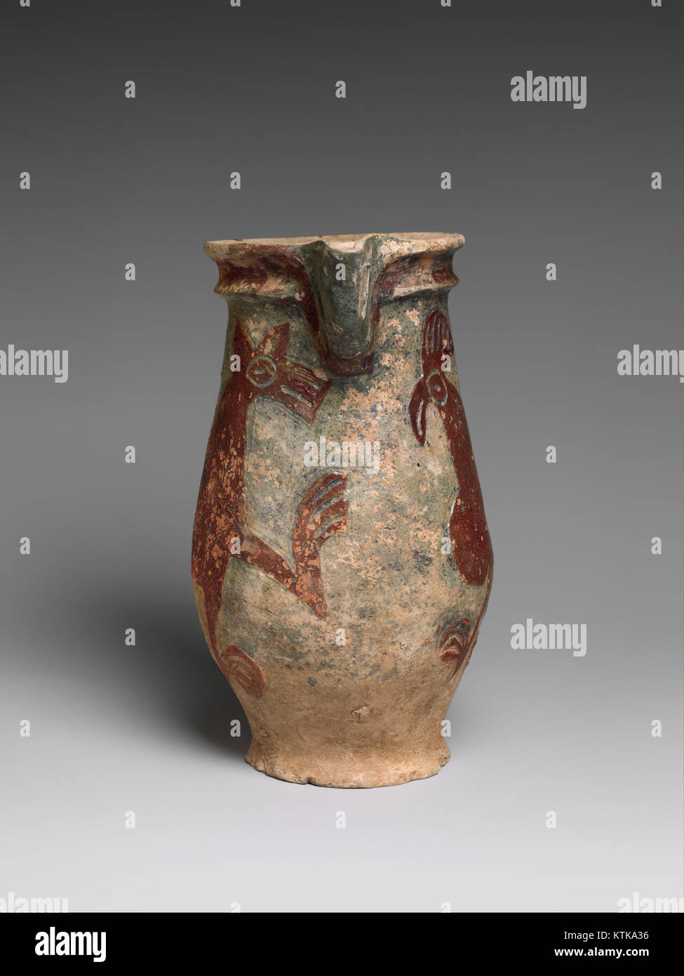 This barrel-shaped jug features an intricate design with depictions of ...