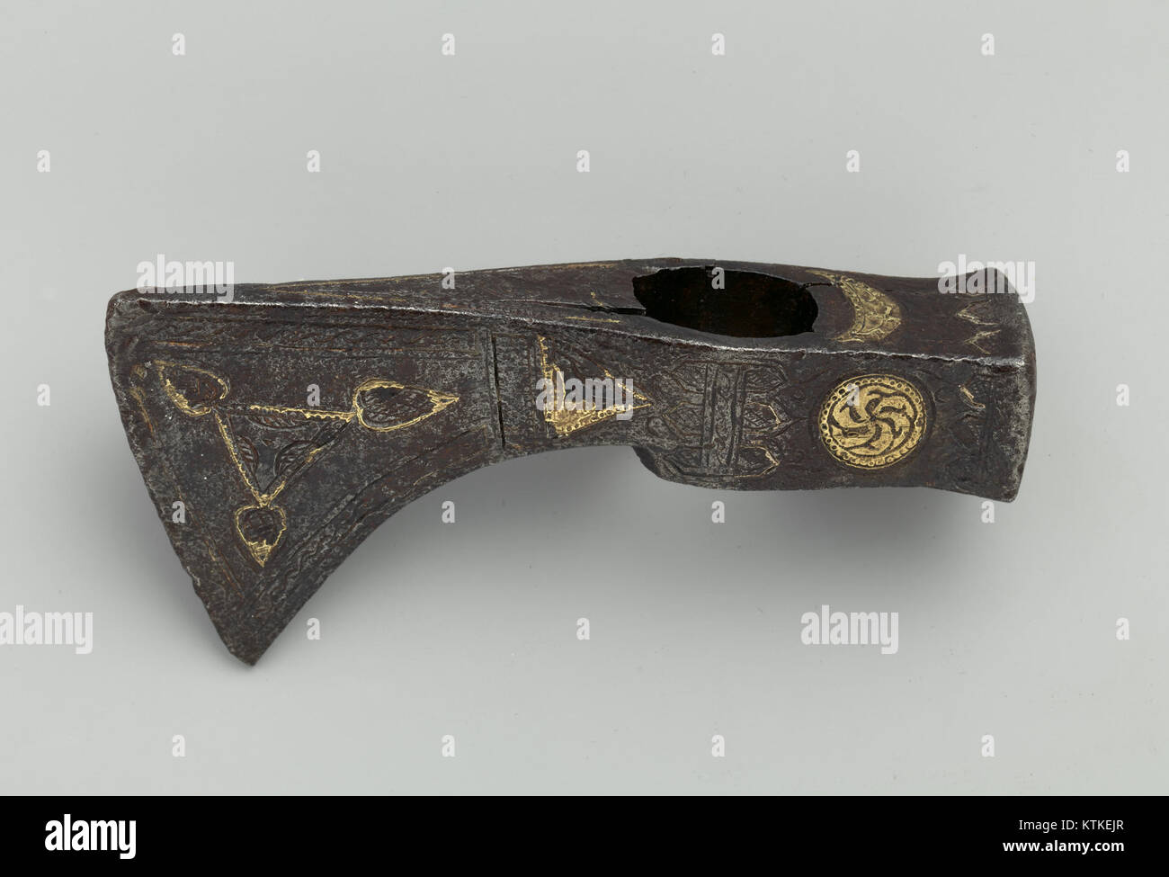 The axe head in this image is a historical artifact, likely from the ...