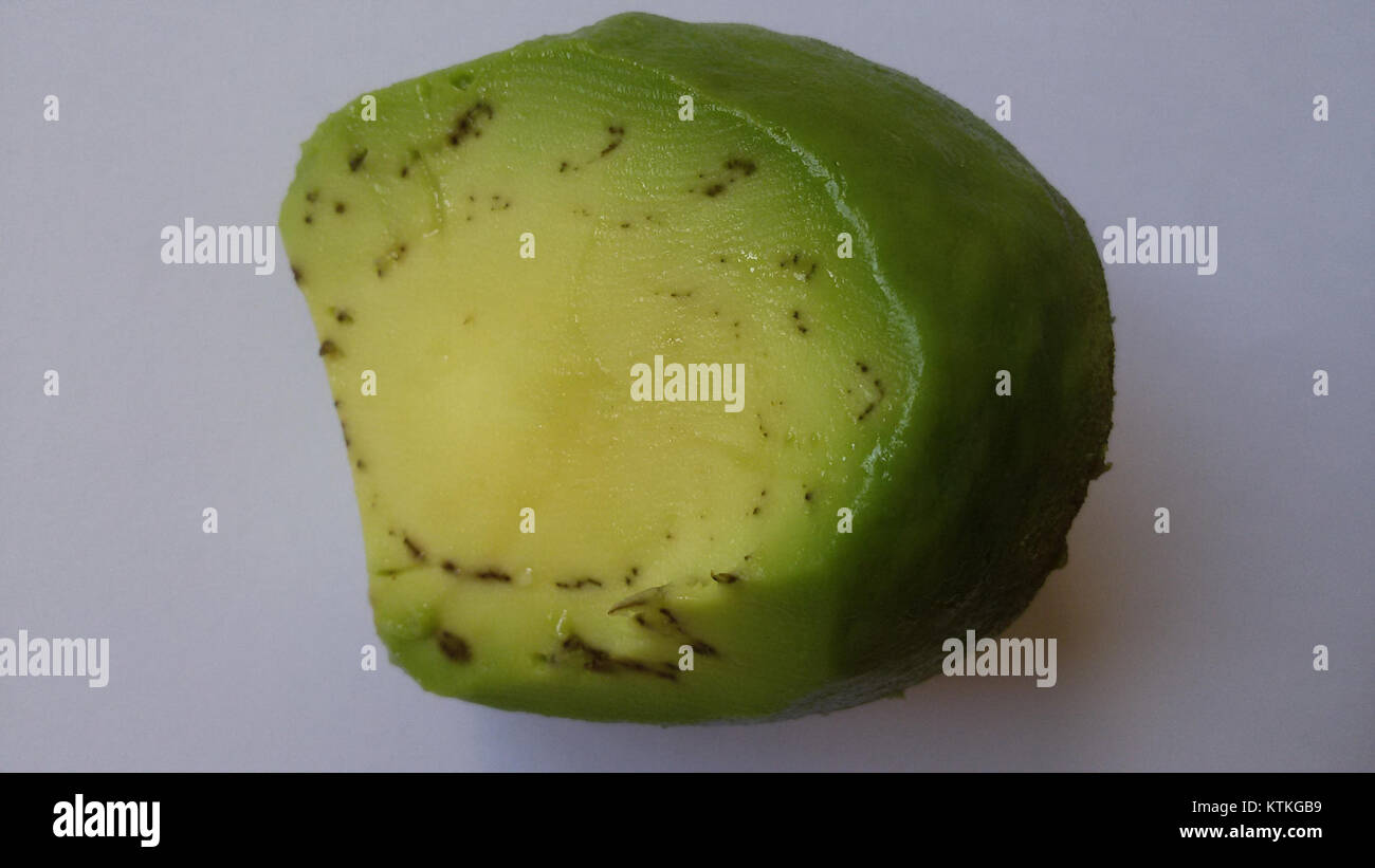 The image shows the flesh of an avocado, characterized by its soft ...