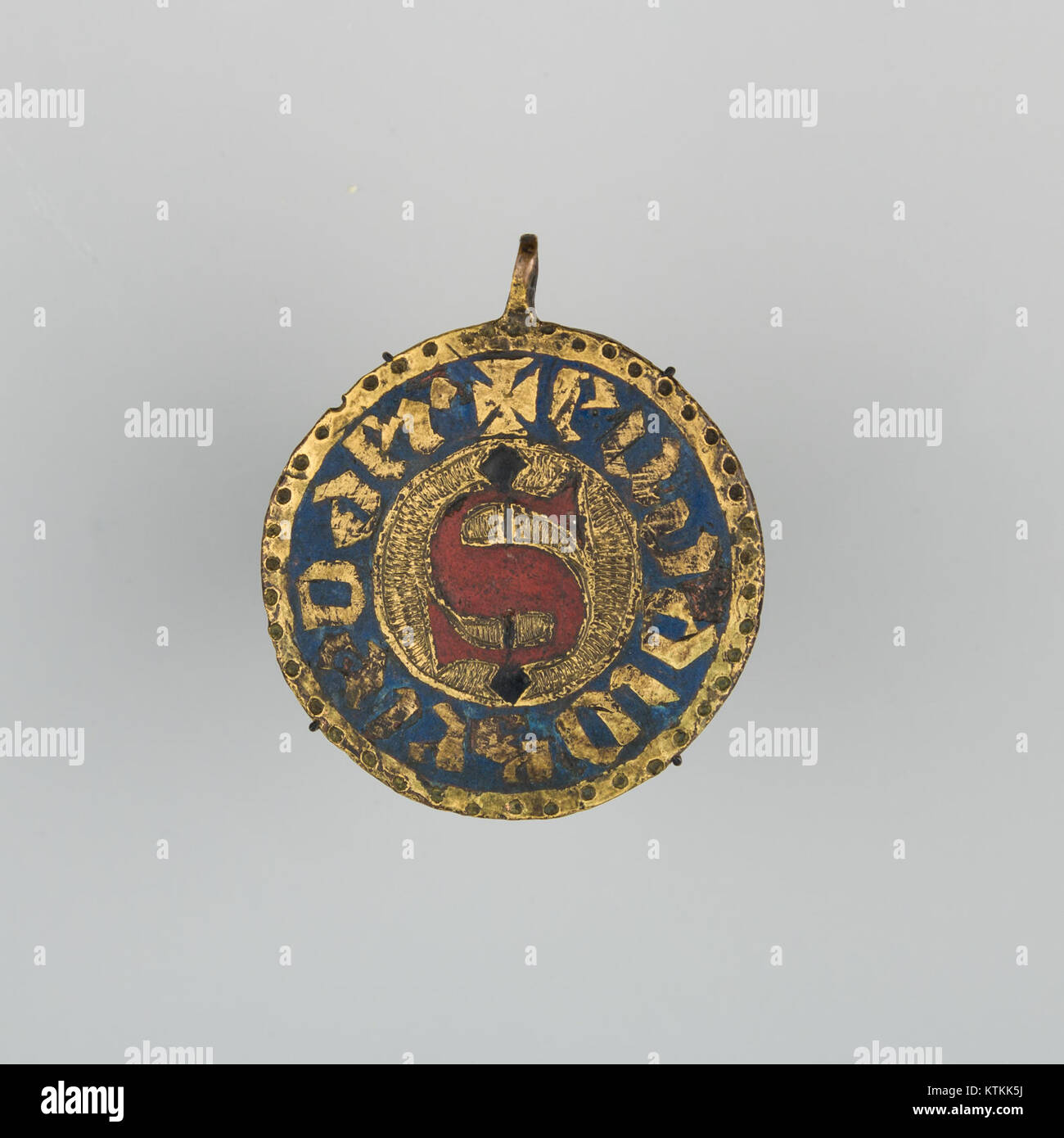 This badge, possibly from a horse harness, features intricate metalwork ...
