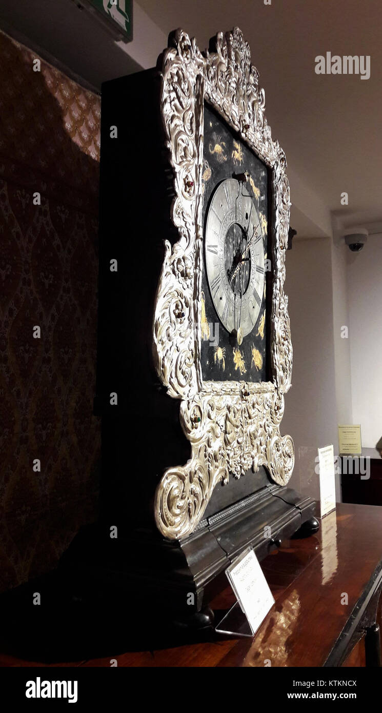 This Augsburg table clock features intricate designs with the signs of ...