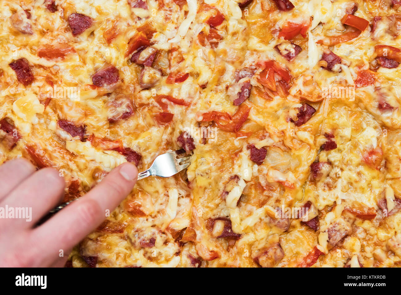 Man hand pins a pizza with a fork, close-up, like a background Stock ...