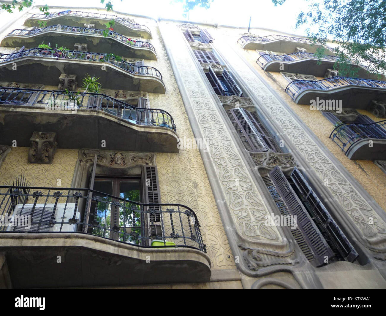 This image features the facades of buildings in Barcelona, showcasing ...