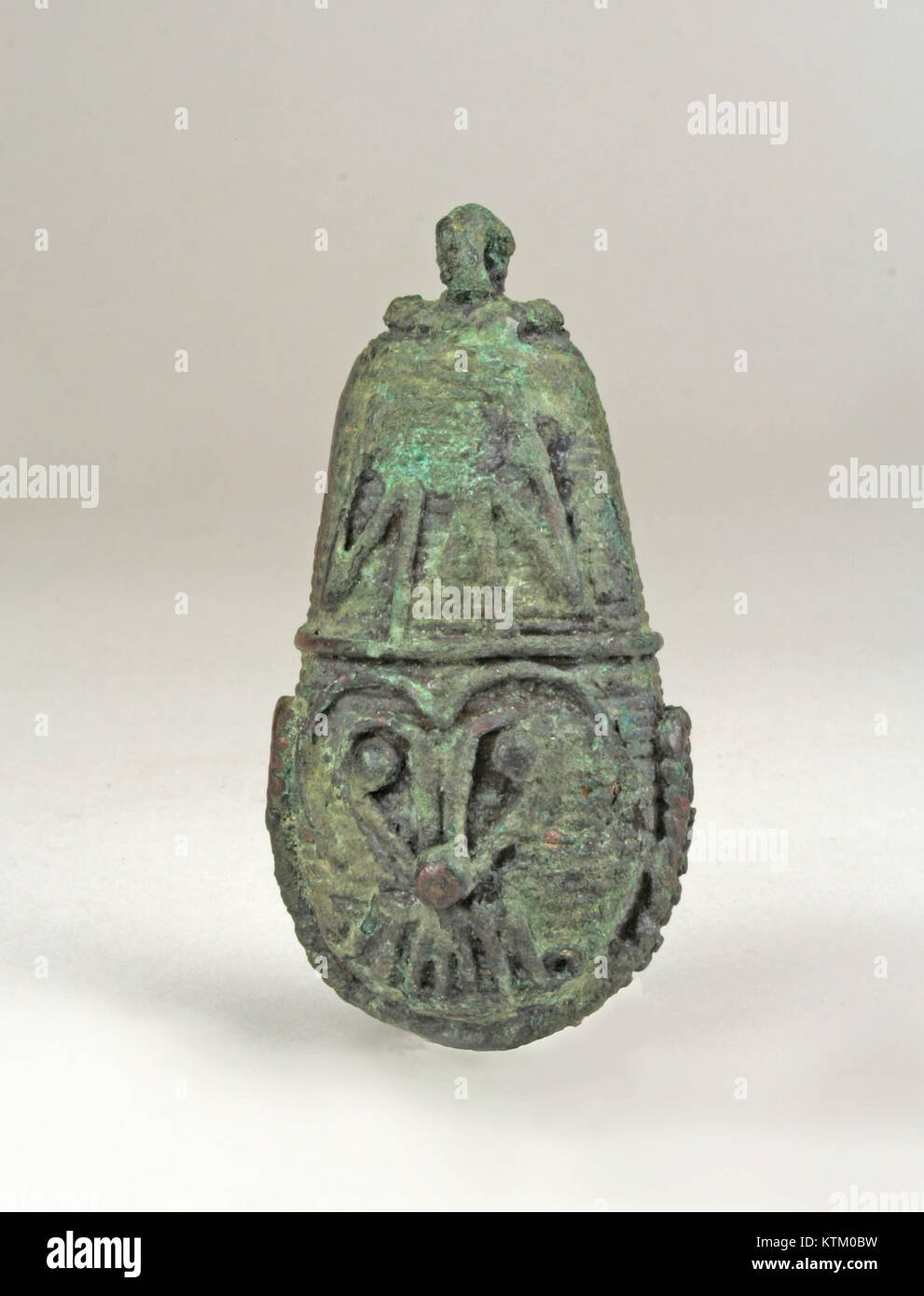 This bell, featuring the face of Tlaloc, the Aztec god of rain, is a ...