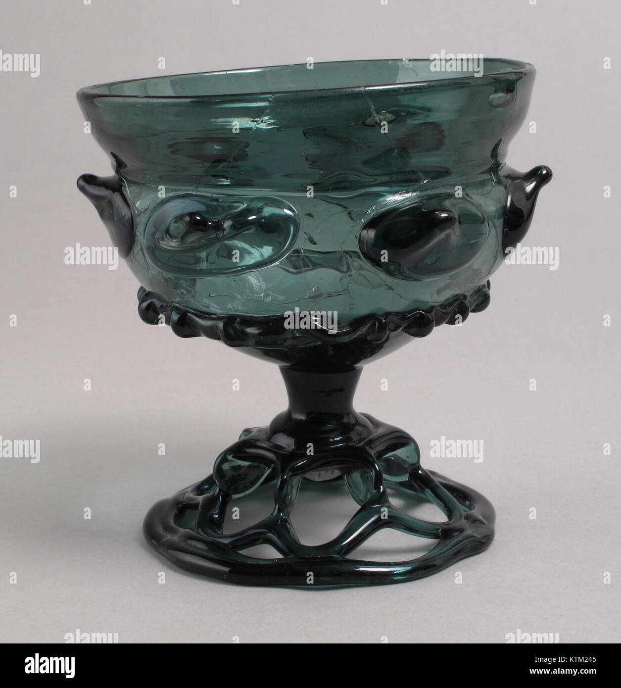 This beaker, featuring an openwork foot, is a decorative artifact from ...