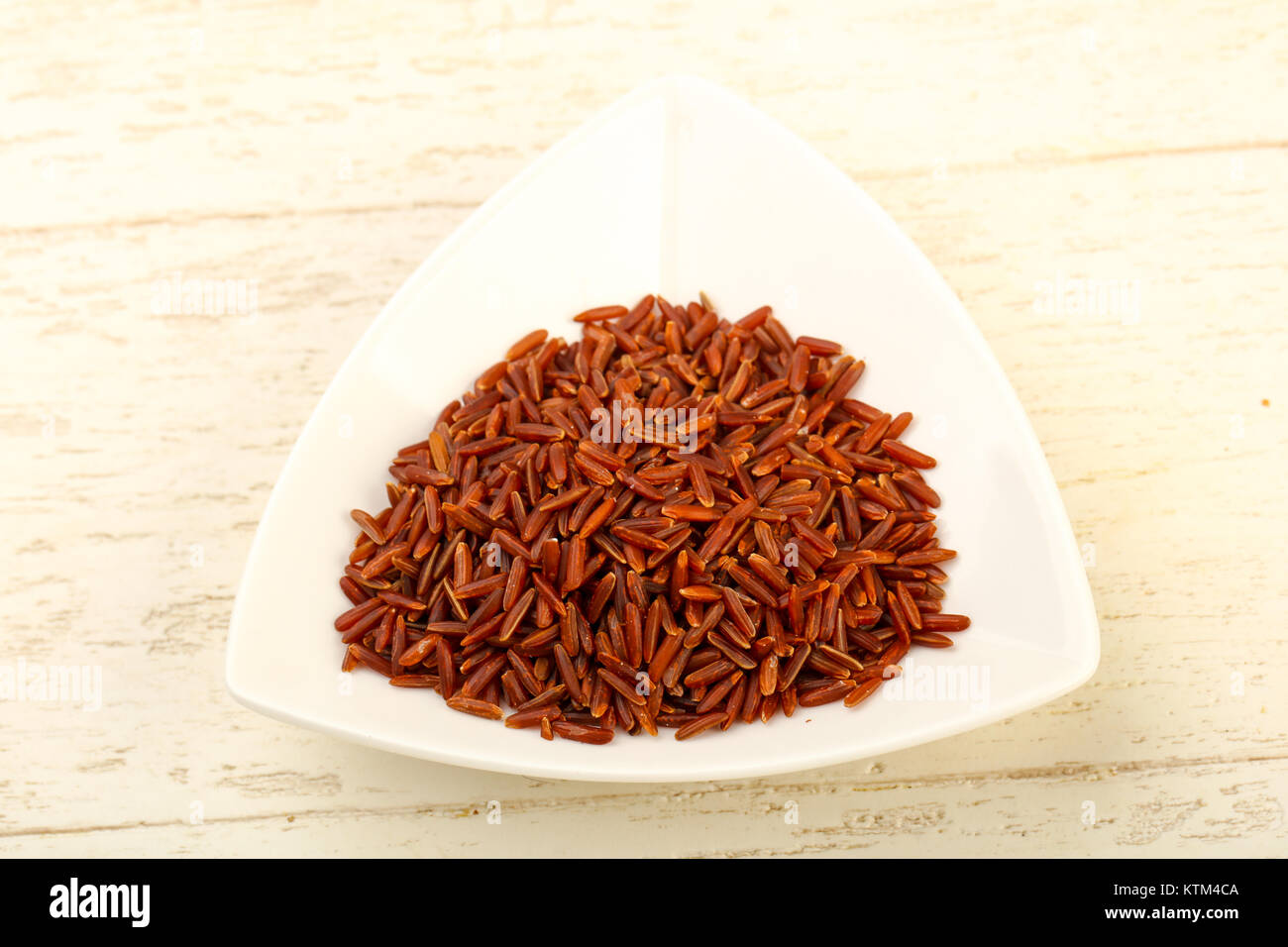 Raw Brown rice in the bowl over wooden background Stock Photo - Alamy