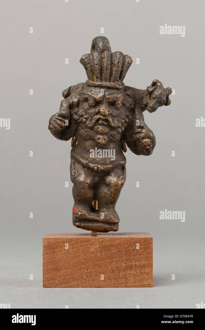 This ancient artwork depicts the Egyptian god Bes, shown with a ram ...