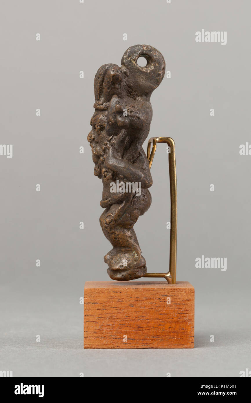 Bes, an ancient Egyptian deity, is depicted carrying a ram over his ...