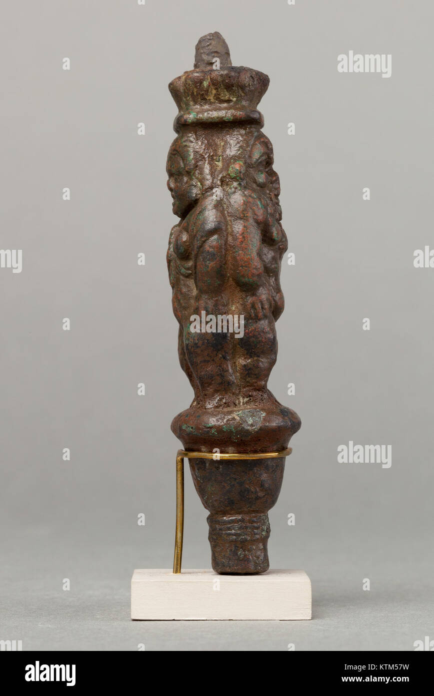 This image depicts the ancient Egyptian god Bes, shown standing on a ...