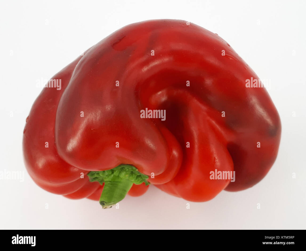 A red bell pepper in a bent shape, photographed in 2017, highlighting ...