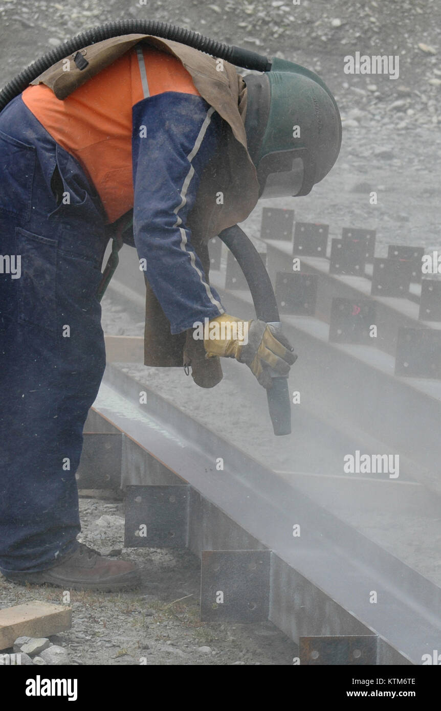 tradesman sandblasting I beams for building project Stock Photo - Alamy