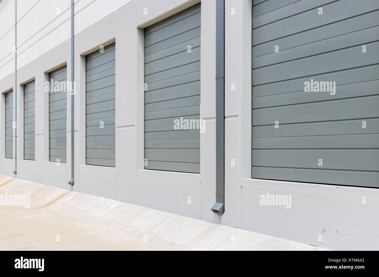 New construction warehouse loading dock white walls gray metal sliding ...