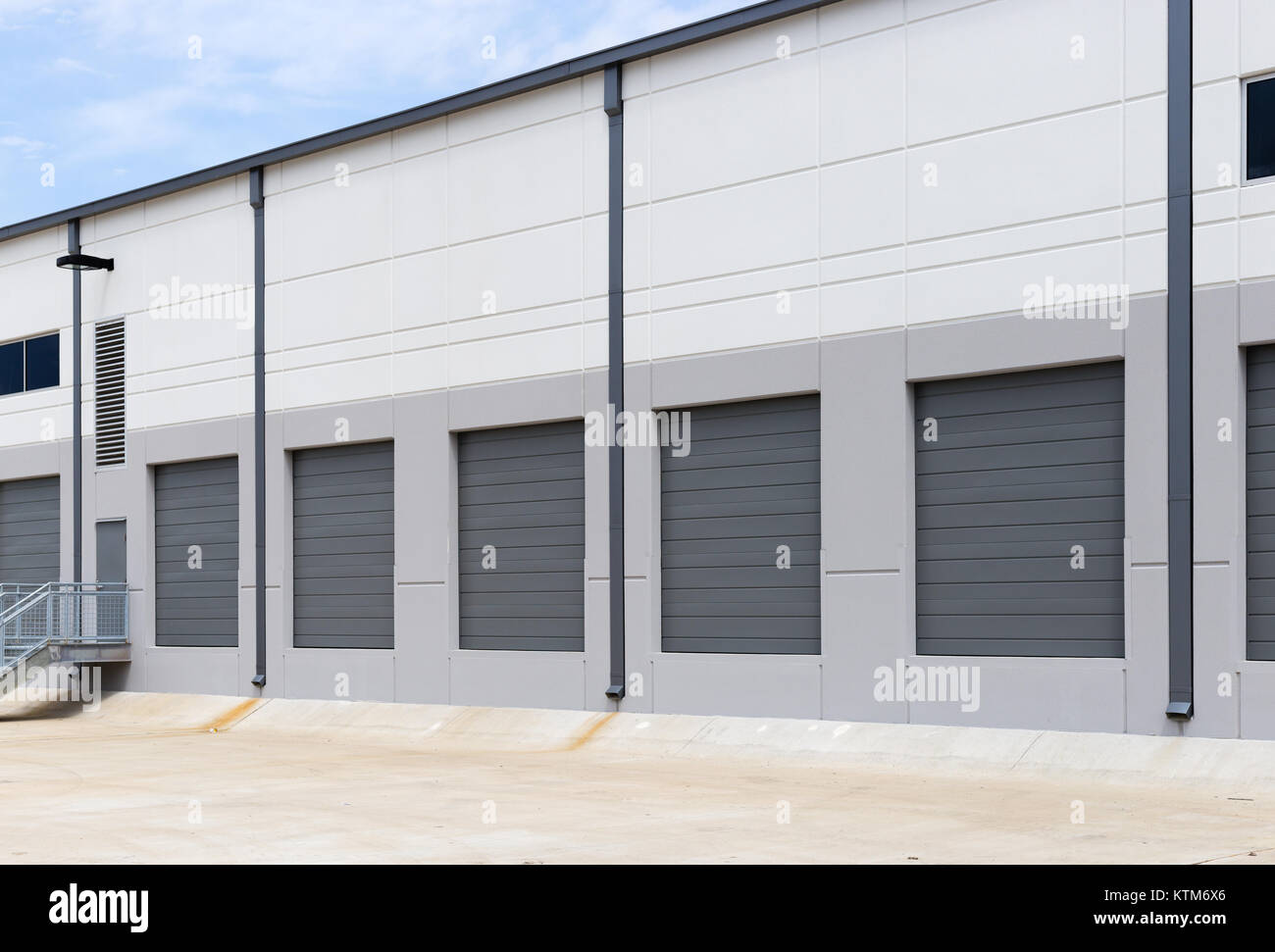 New construction warehouse loading dock white walls gray metal sliding ...