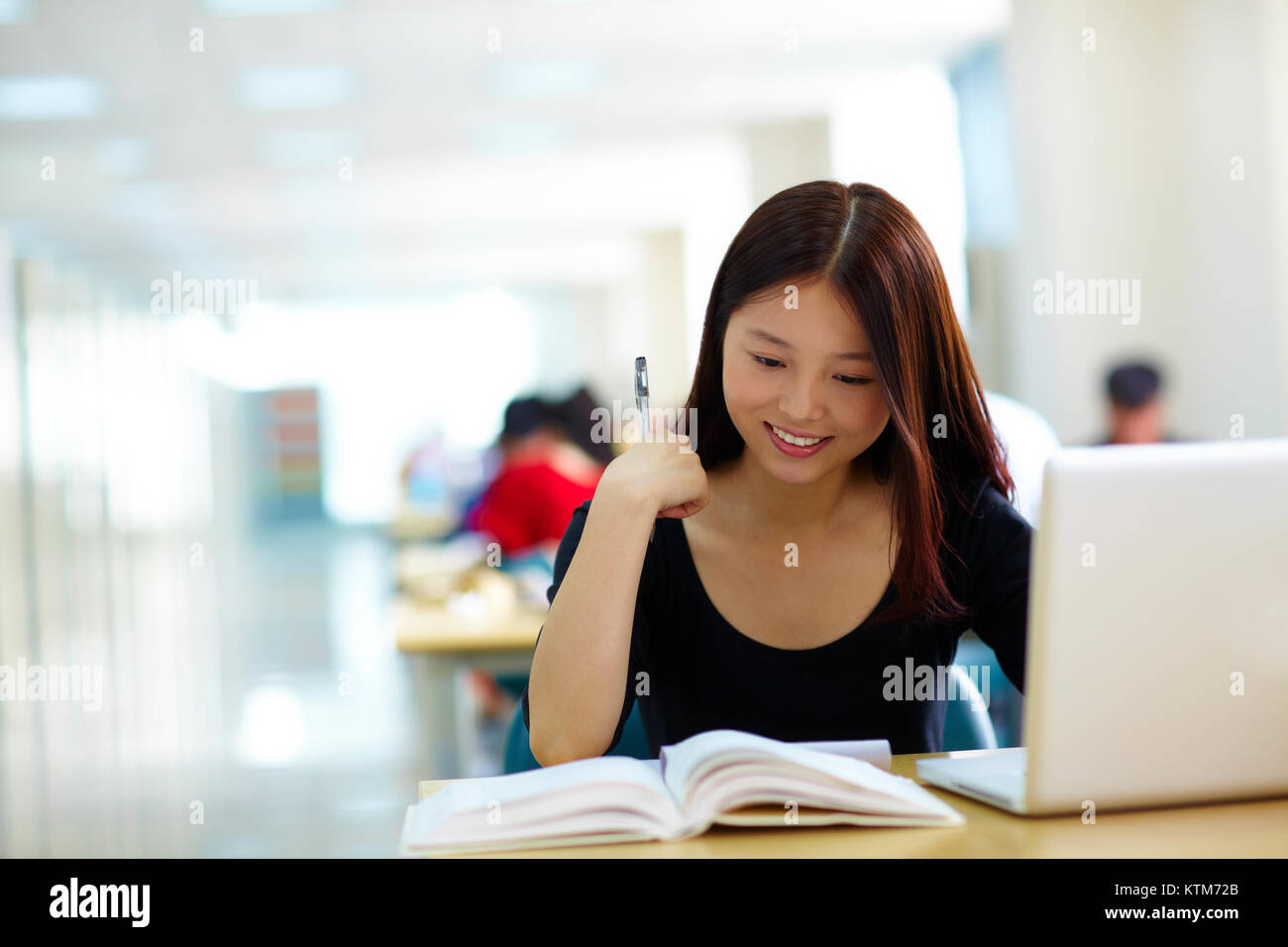 one young Chinese female univeristy student study in the library with ...