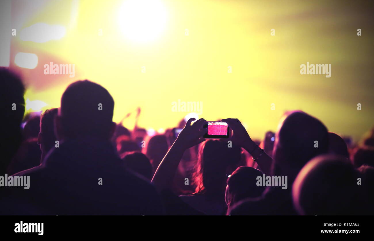 girl using smart phone at live concert and many people Stock Photo - Alamy