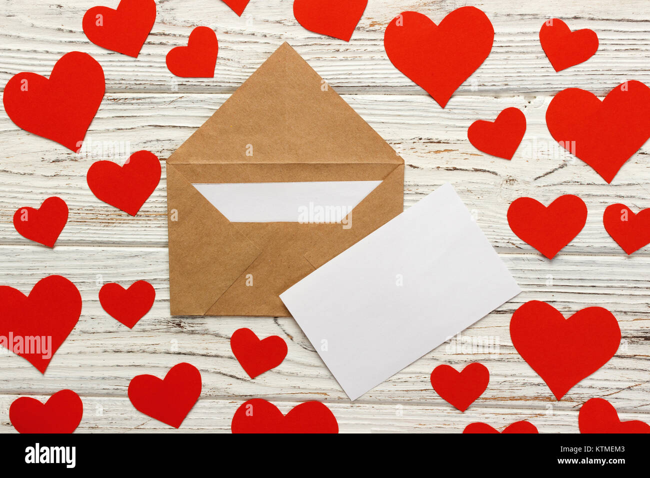 Letter to Valentine Day. Love letter envelope with red hearts on wooden ...