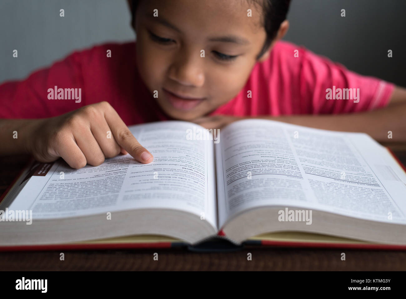 young asian boy reading a book. education concept Stock Photo - Alamy