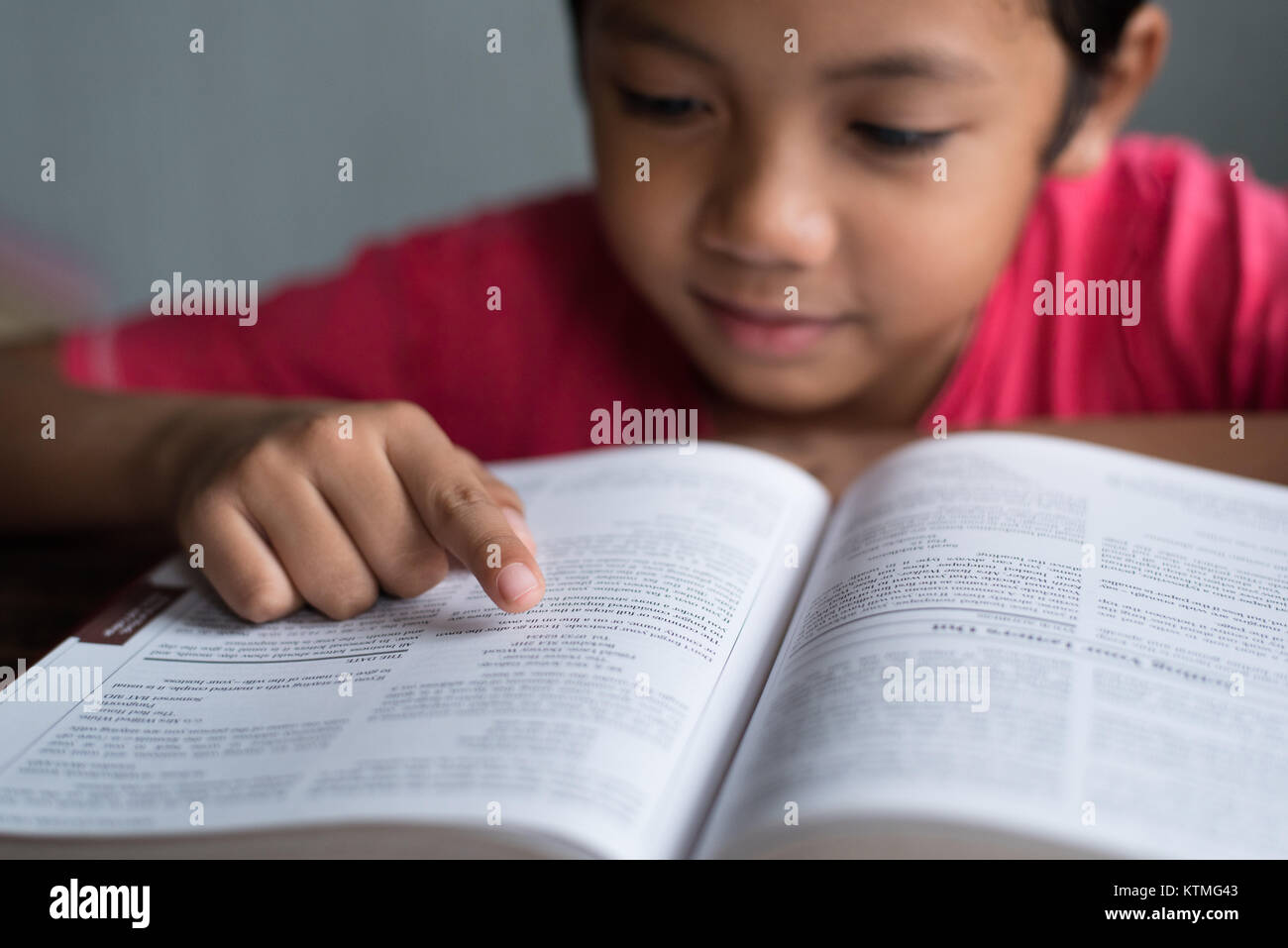 young asian boy reading a book. education concept Stock Photo - Alamy