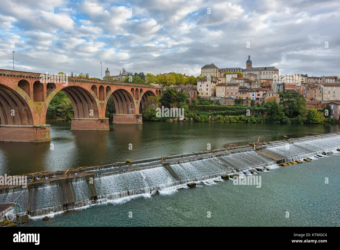 Medieval riverside city with a brick bridge and a small man made ...