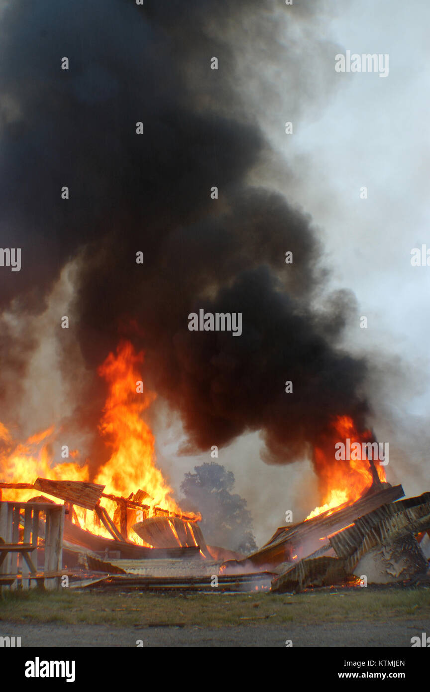 flames and smoke rise from burning farm building Stock Photo - Alamy