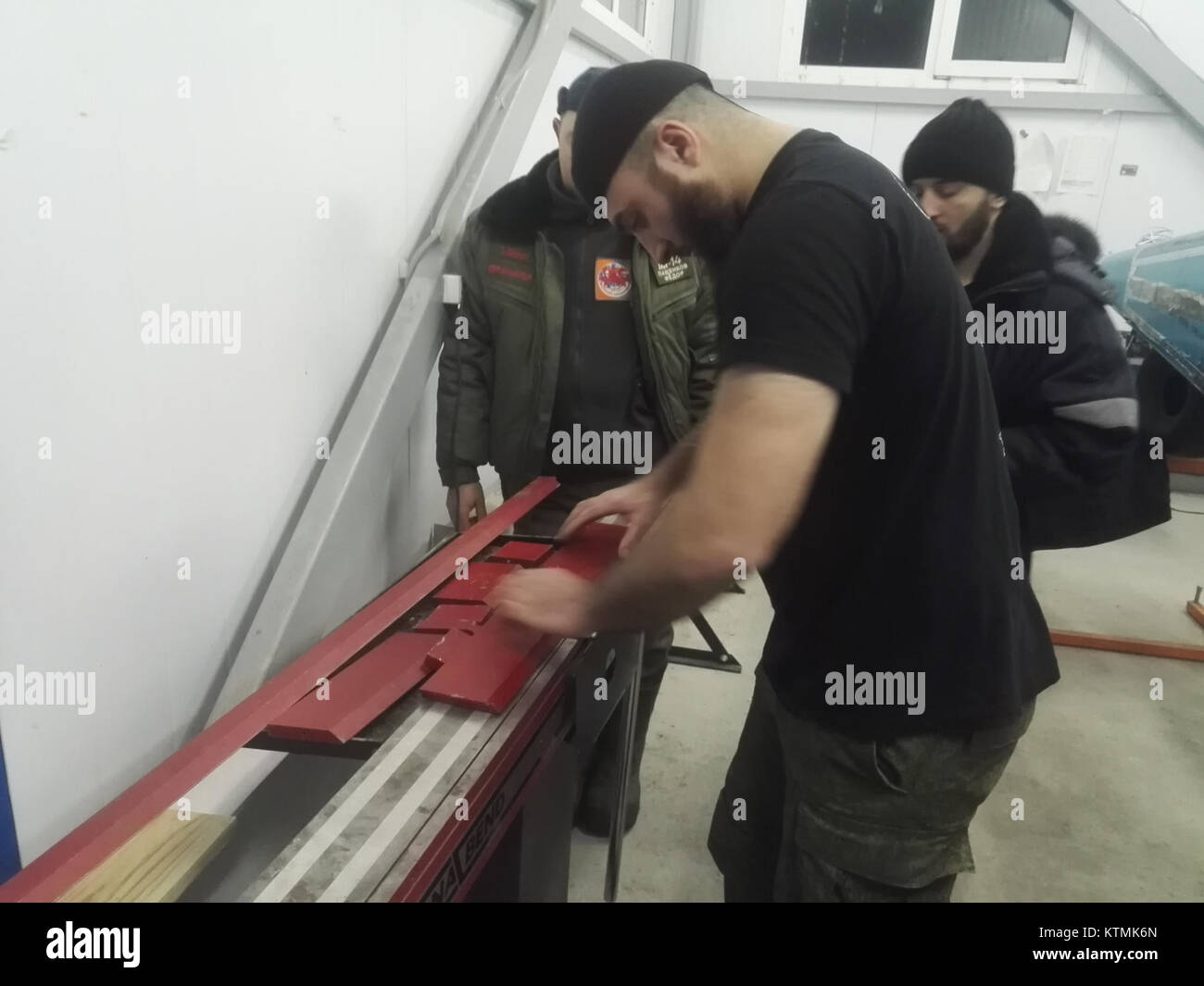 Photograph of a bending machine in operation, used in manufacturing and ...