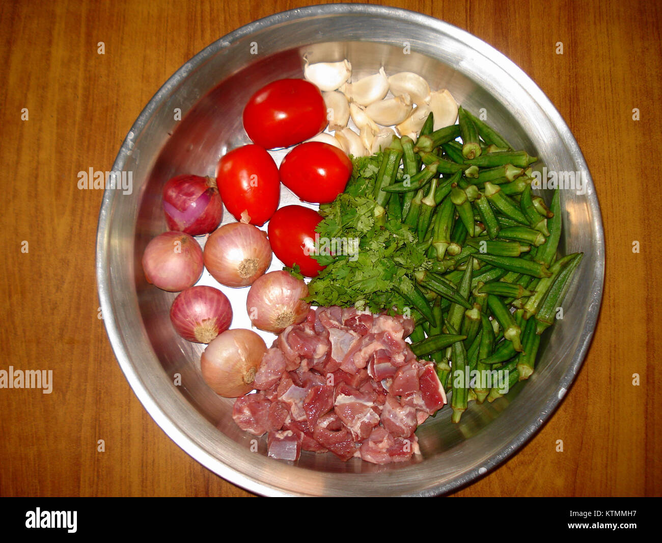 An image depicting the preparation of Bamje, a traditional dish ...