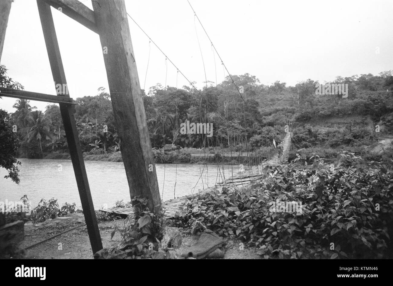 This image shows a damaged suspension bridge, a rare view of a ...