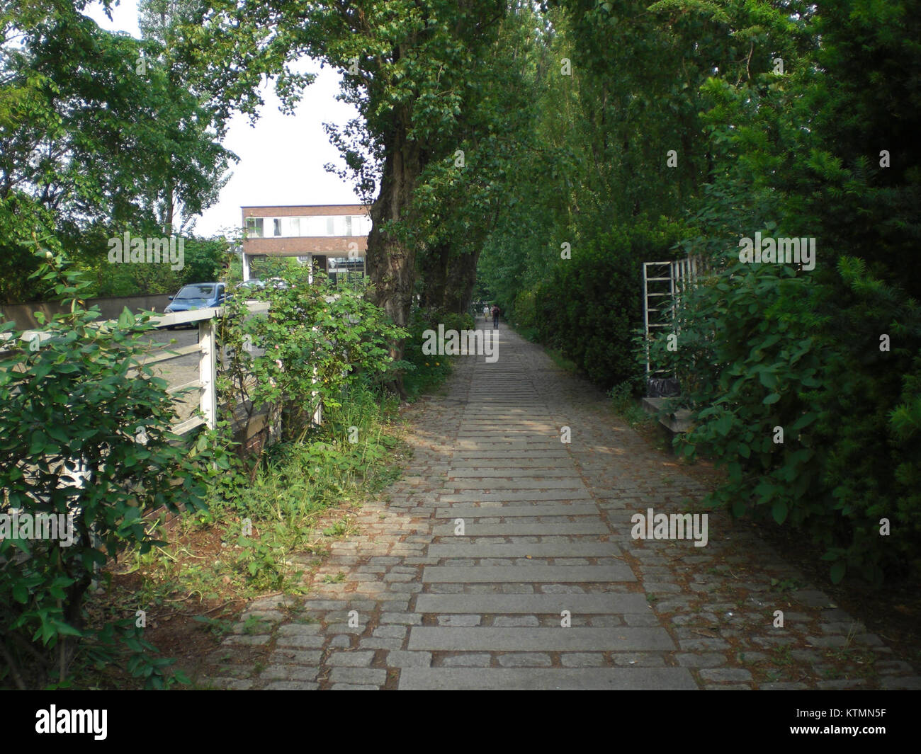 The image depicts a public footpath in Berlin, showcasing its role as a ...