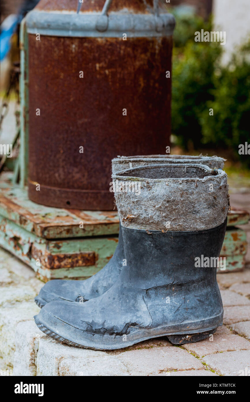 Village detailed objects concept. Very old wellingtons and copper ...