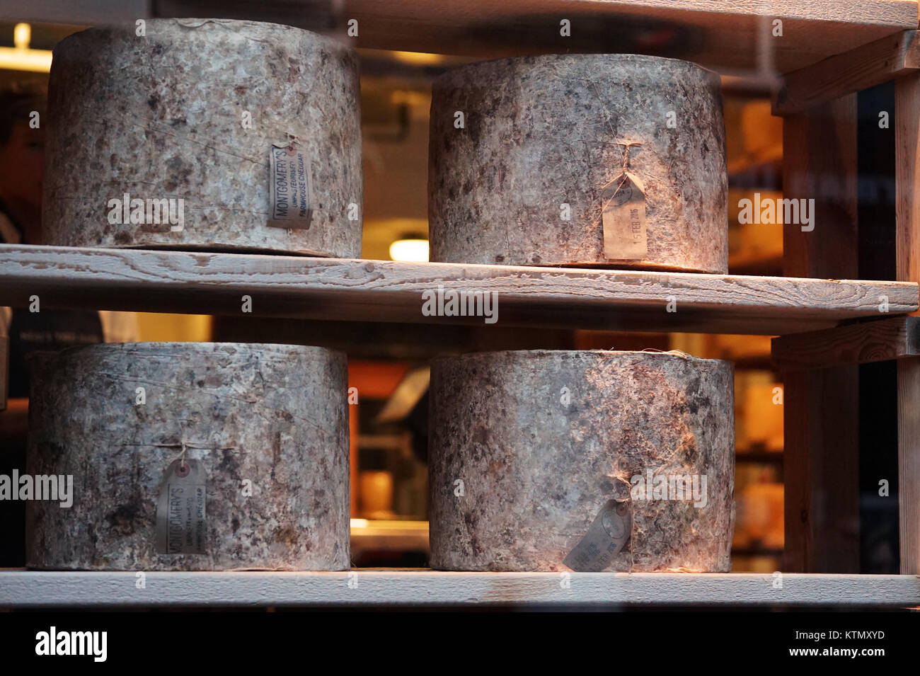 Cheese factory / shop displaying four wheels of ageing organic artisan ...