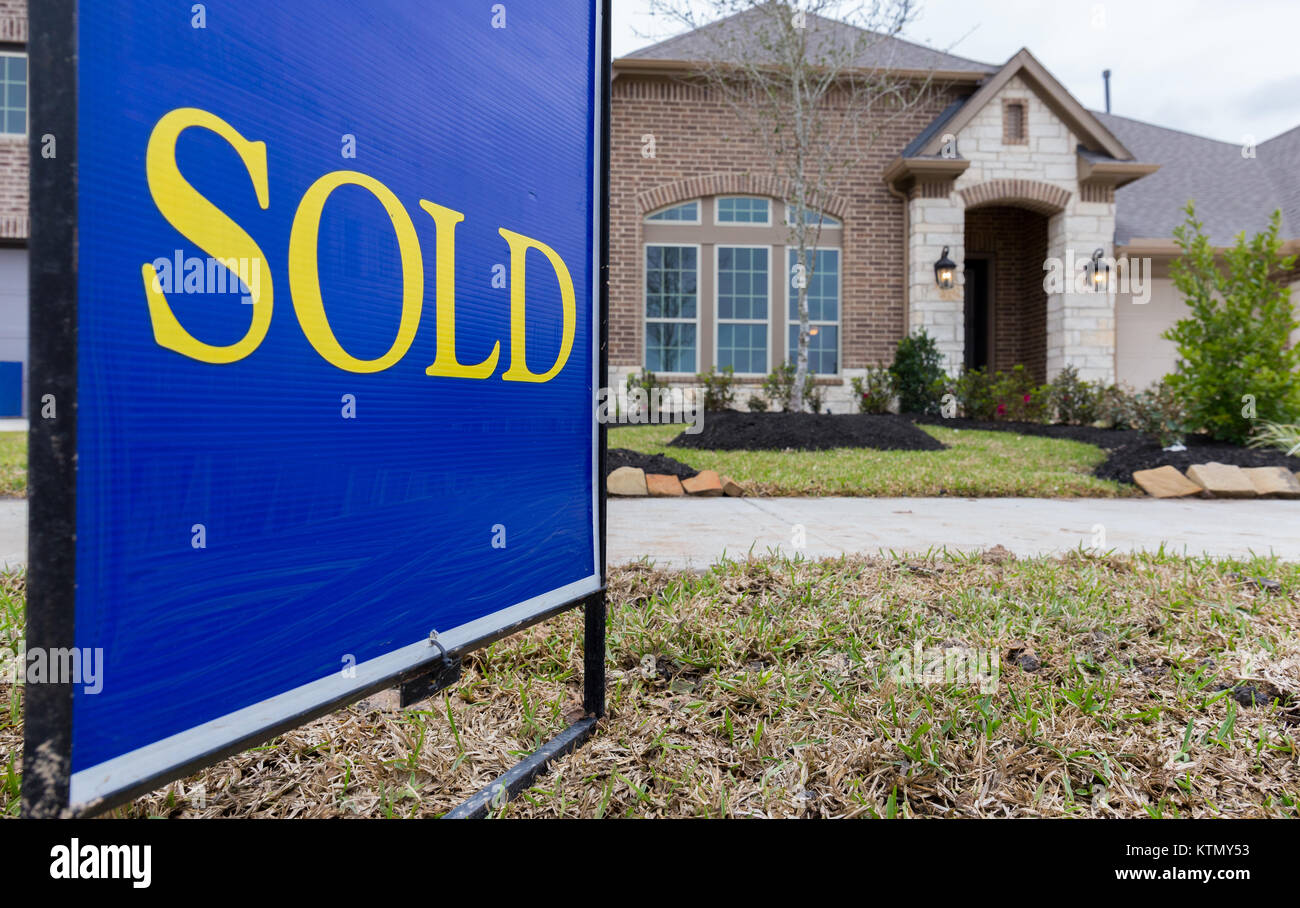 Sold sign posted in front a new construction house Stock Photo - Alamy