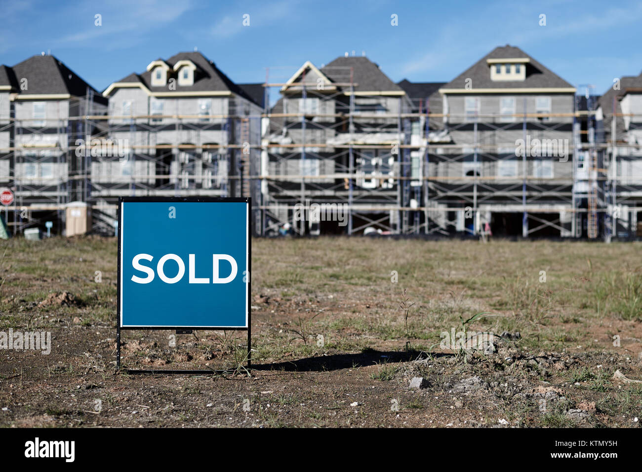 SOLD Sign Posted in Front of New Construction Houses in a Up-and-Coming ...