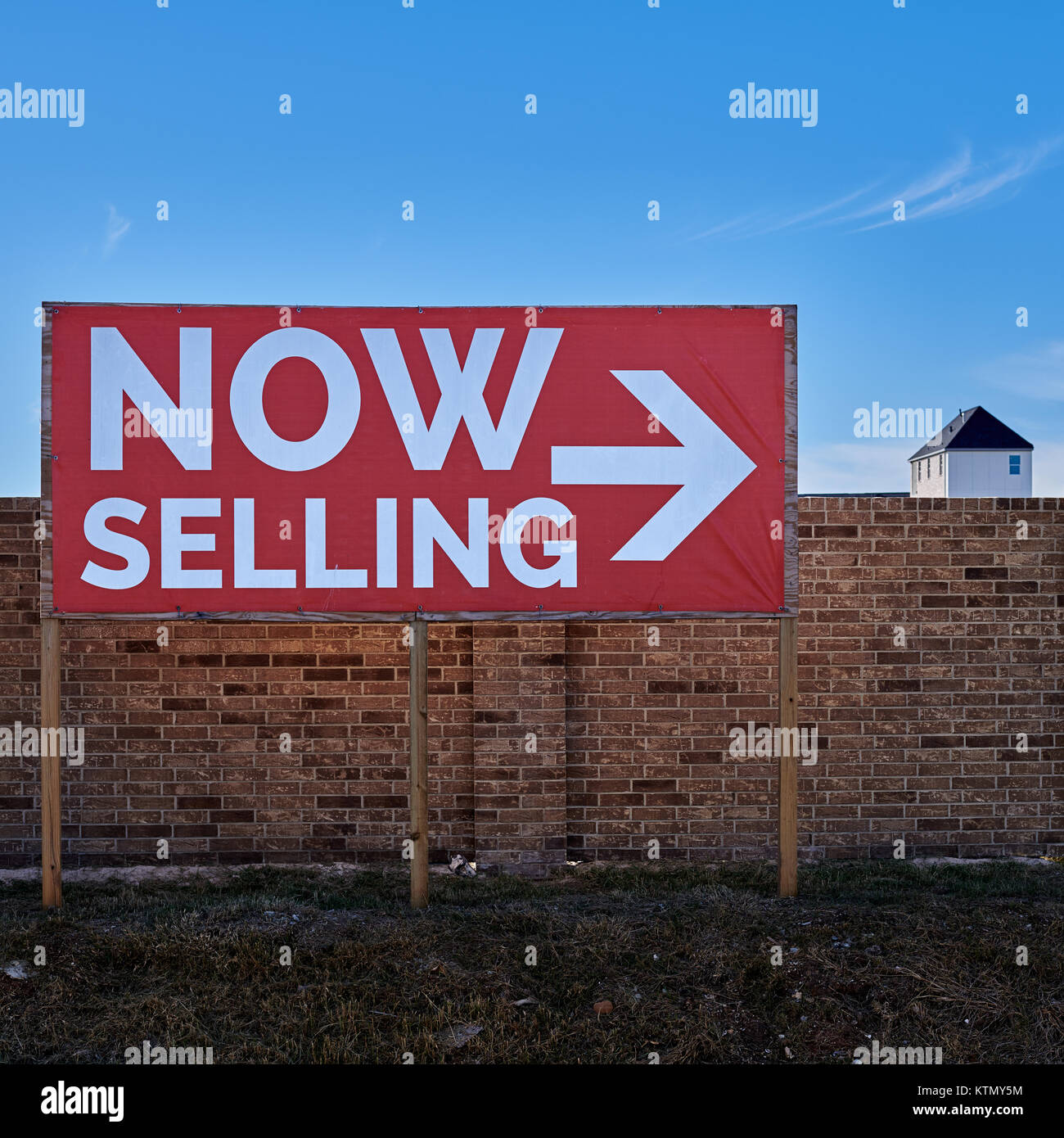 Now Selling Sign Posted in Front of a New Construction Home in a Up-and ...