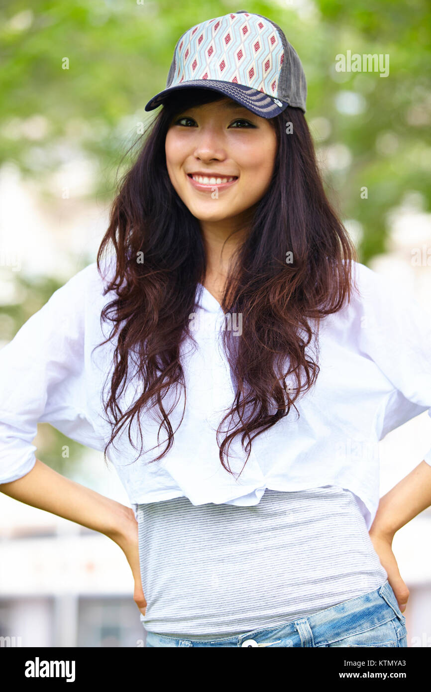 one pretty young asian woman looking at camera smile outdoor Stock Photo - Alamy