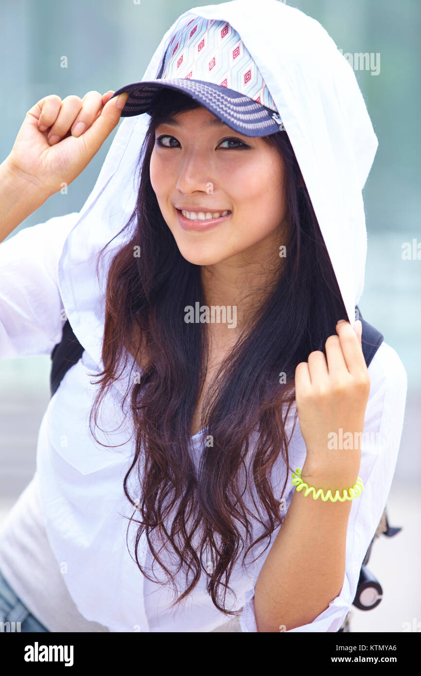 one pretty young asian woman looking at camera smile outdoor Stock Photo - Alamy