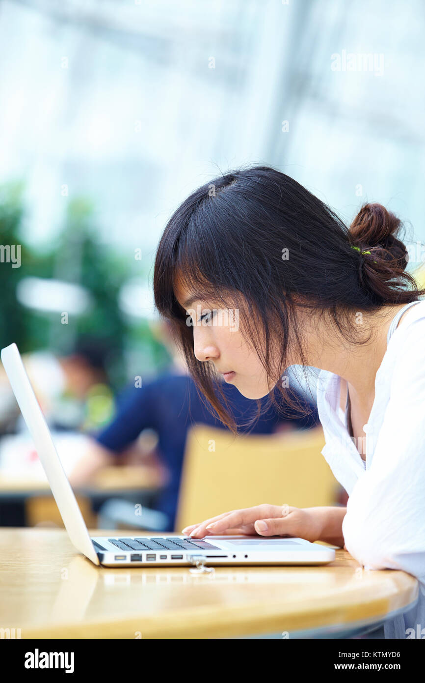 one pretty young Chinese college student in library Stock Photo - Alamy