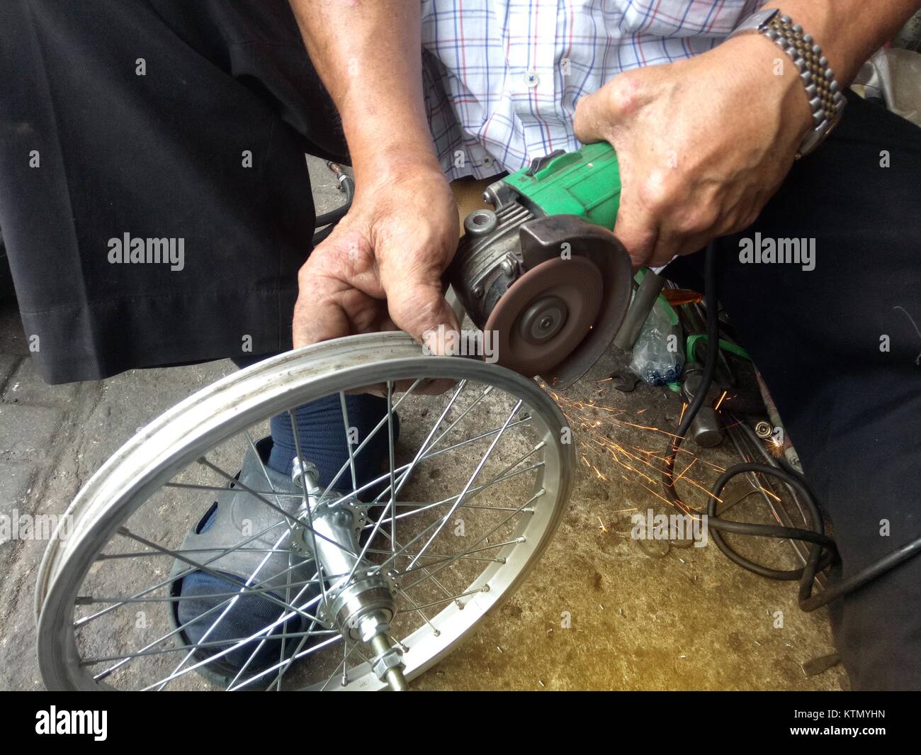 Grinding machine works and sparking with bicycle wheel by male Stock ...