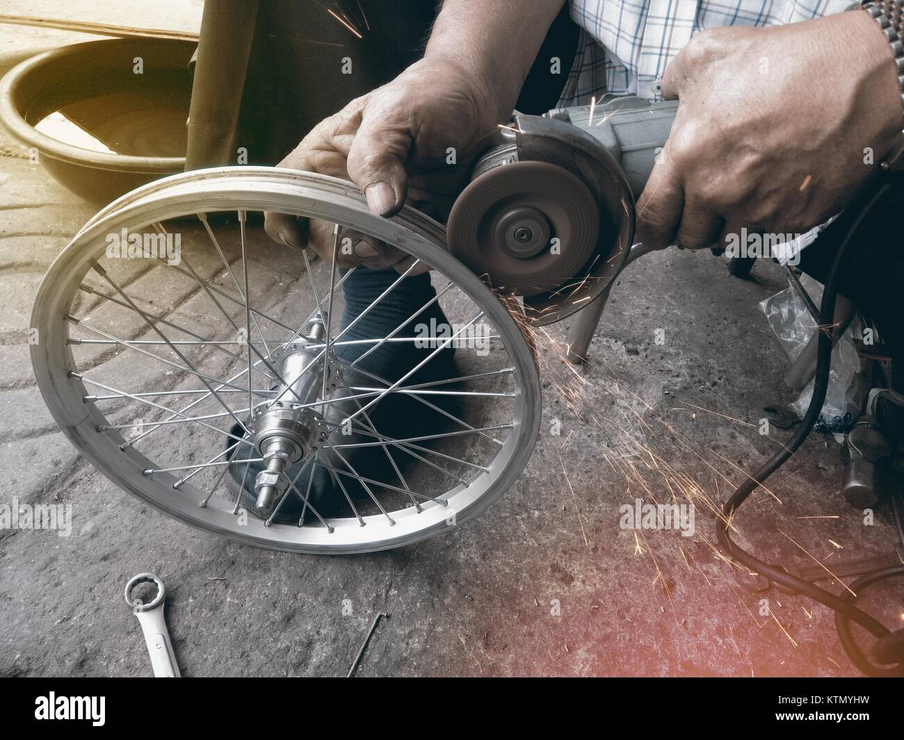 Grinding machine works and sparking with bicycle wheel by male Stock ...
