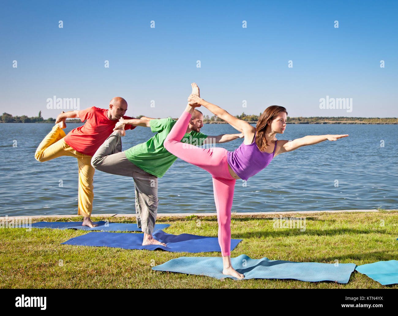 People in group practice Yoga asana on lakeside. Yoga concept Stock ...