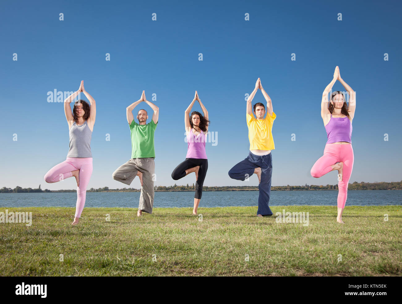 People in group practice Yoga asana on lakeside. Yoga concept Stock ...