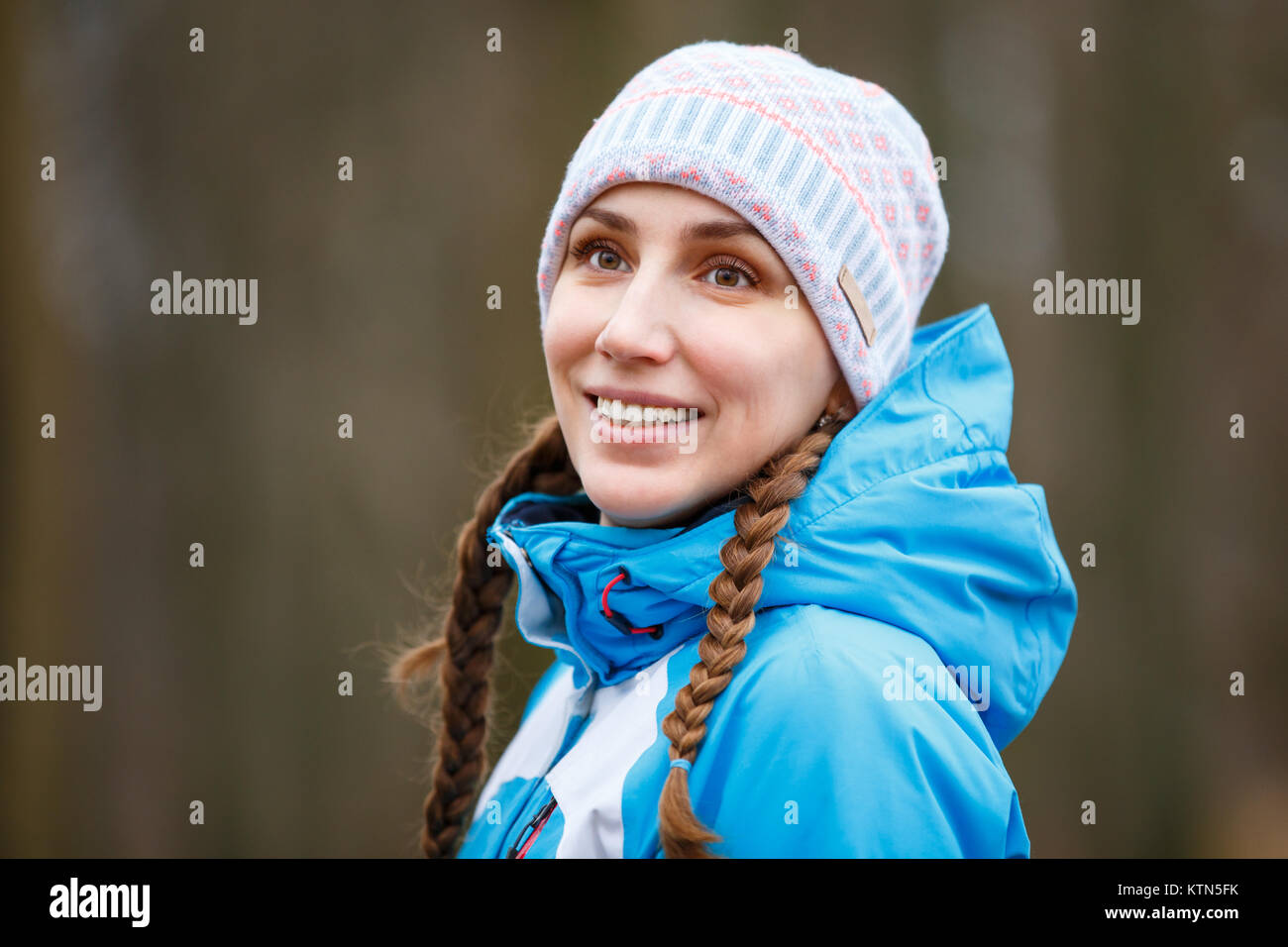 Young happy woman with braids on winter activity. Image with copy space ...