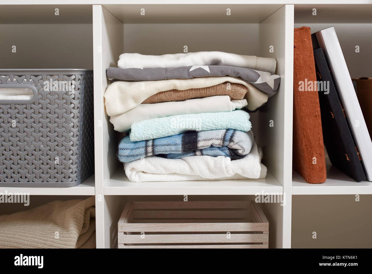 white rack with shelves full of stuff Stock Photo - Alamy