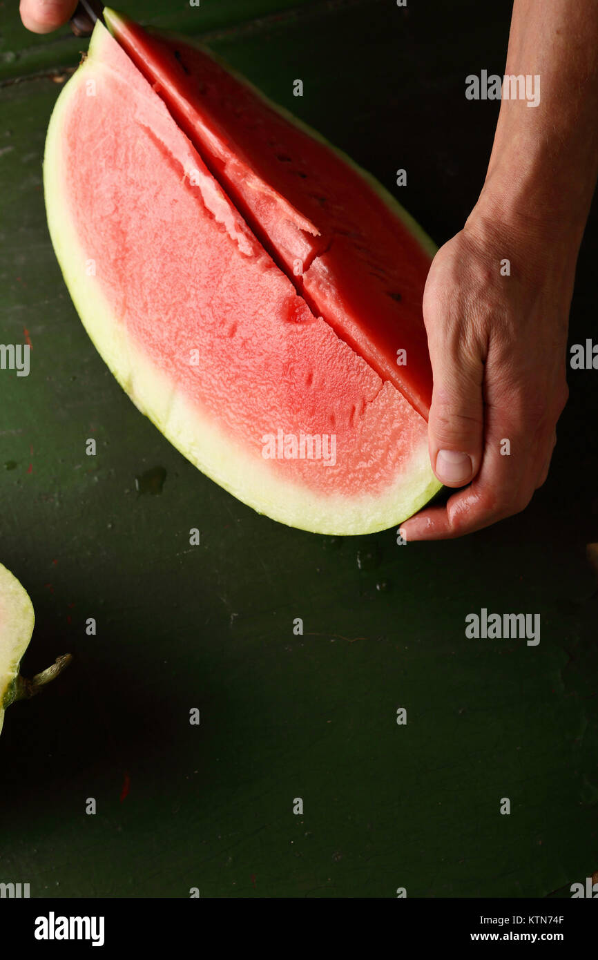Watermelon slice on green background, food closeup Stock Photo - Alamy