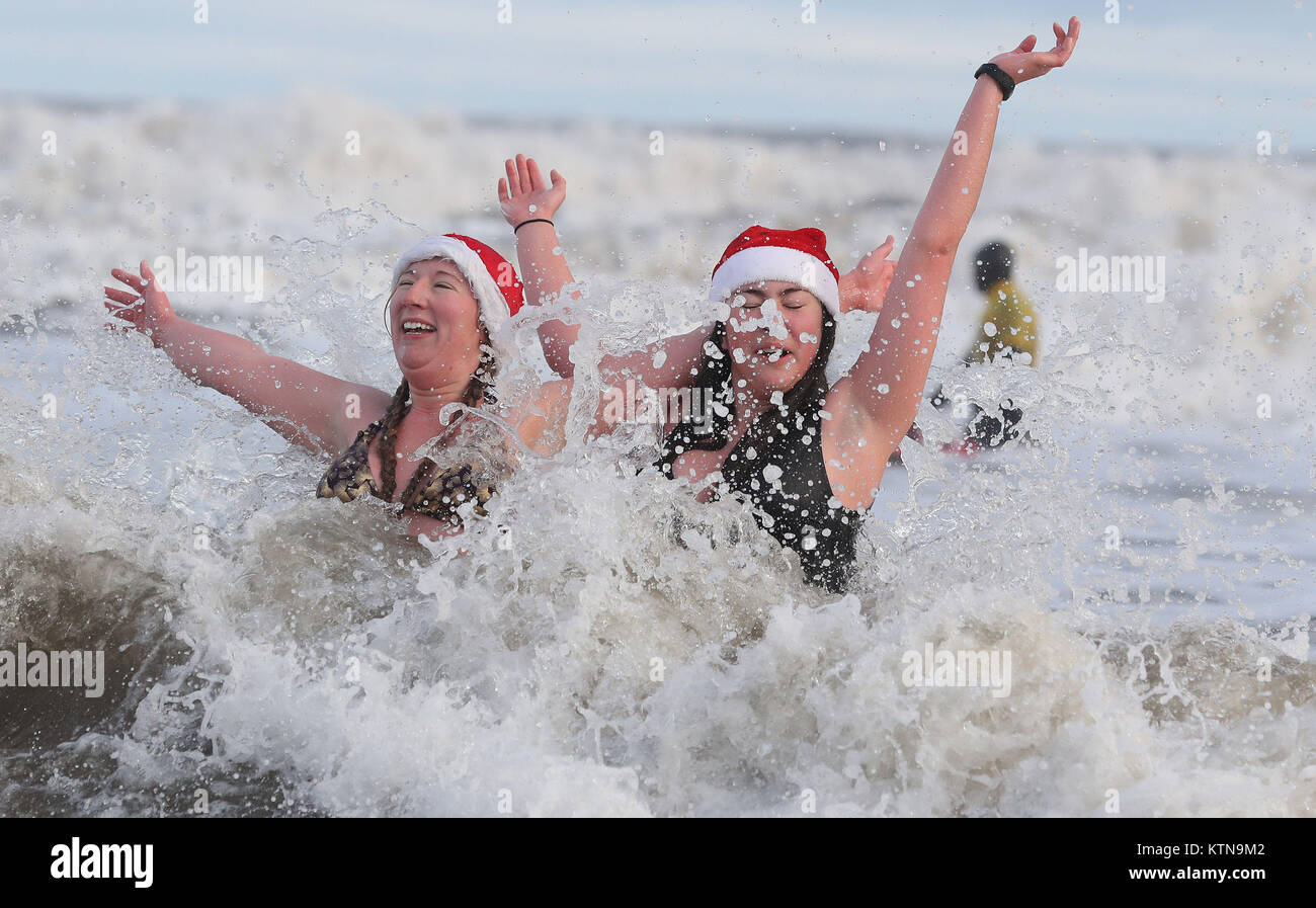 People take a dip in the sea at Tynemouth during the annual Boxing Day ...