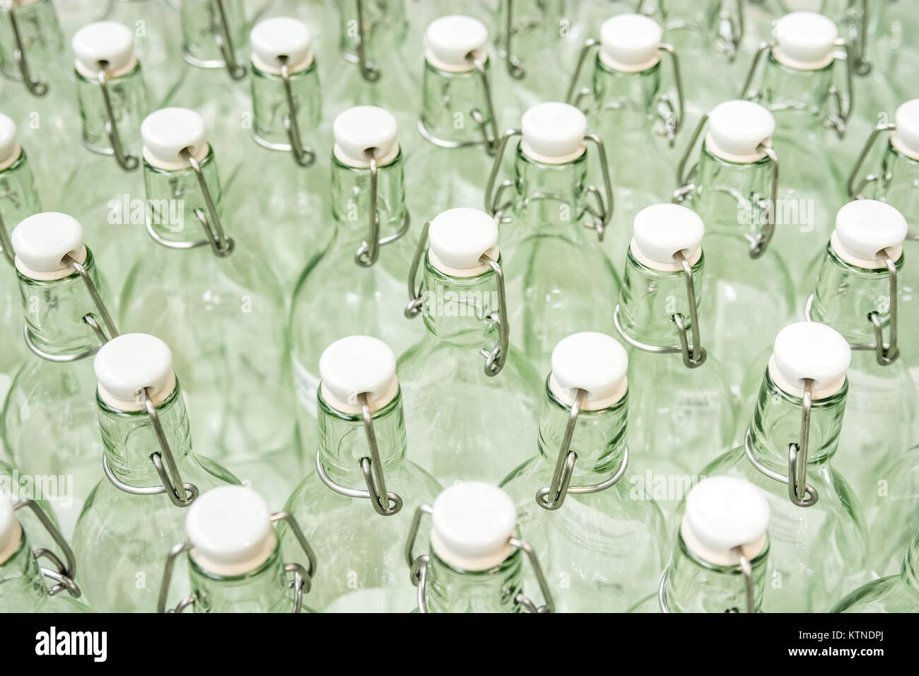 Close up of empty glass bottles with caps in shop Stock Photo - Alamy