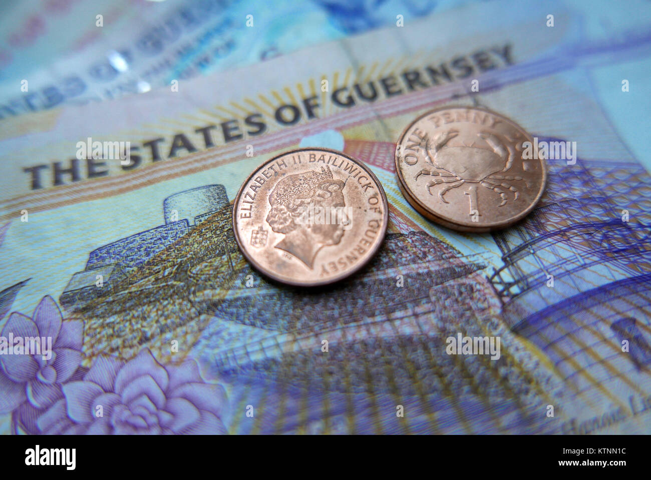 A view of bank notes and coins of the currency Guernsey Pound (GGP ...
