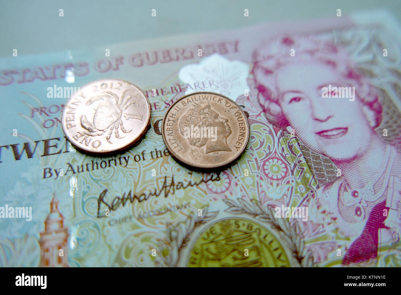 A view of bank notes and coins of the currency Guernsey Pound (GGP ...