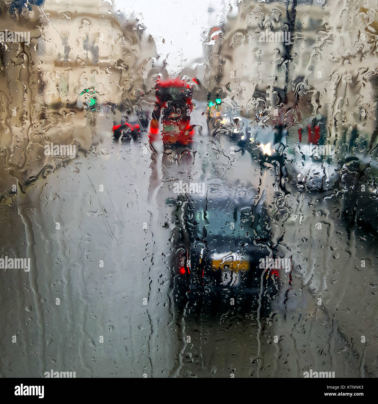 Londons red double decker buses through window with raindrops hi-res ...