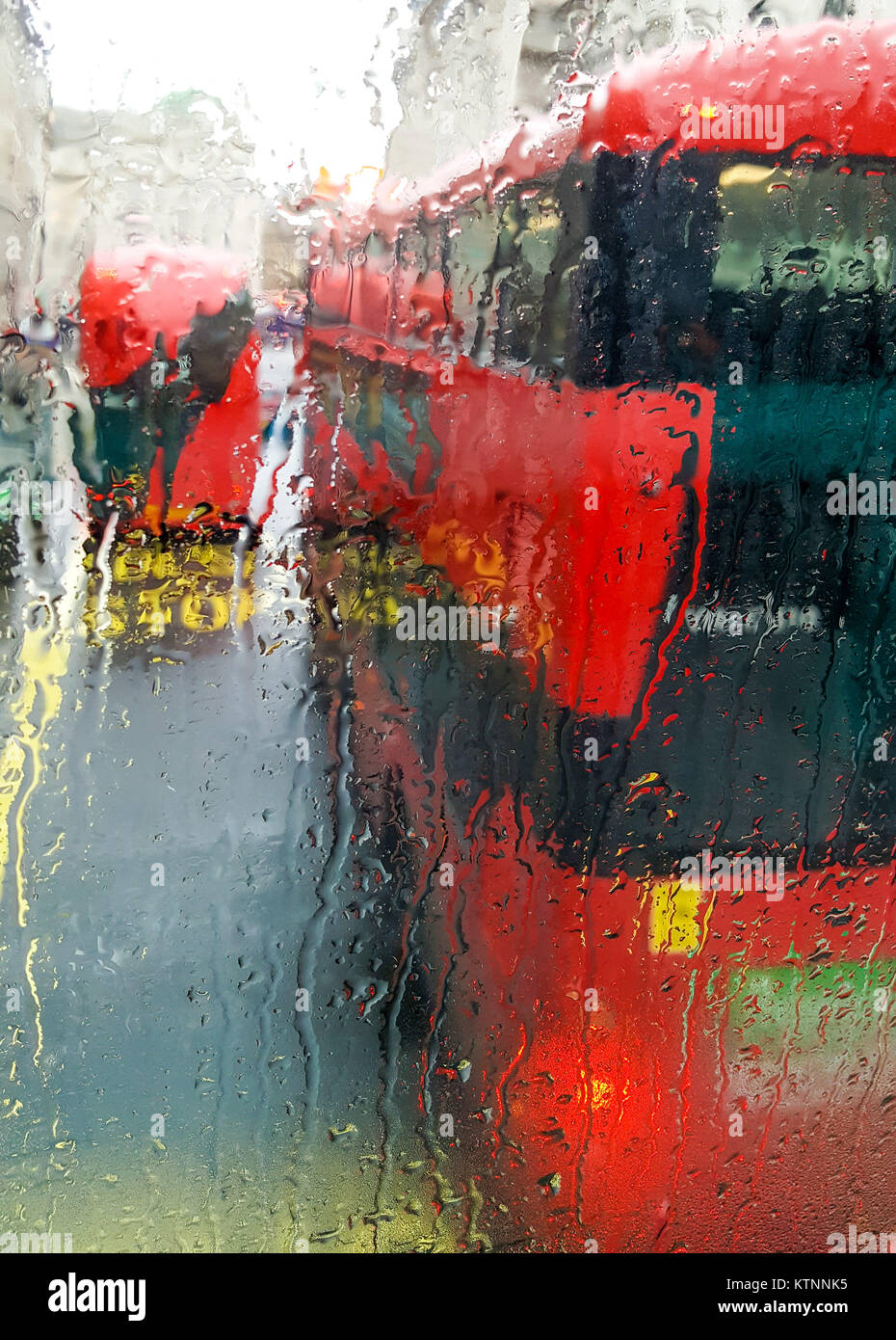 Londons red double decker buses through window with raindrops hi-res ...