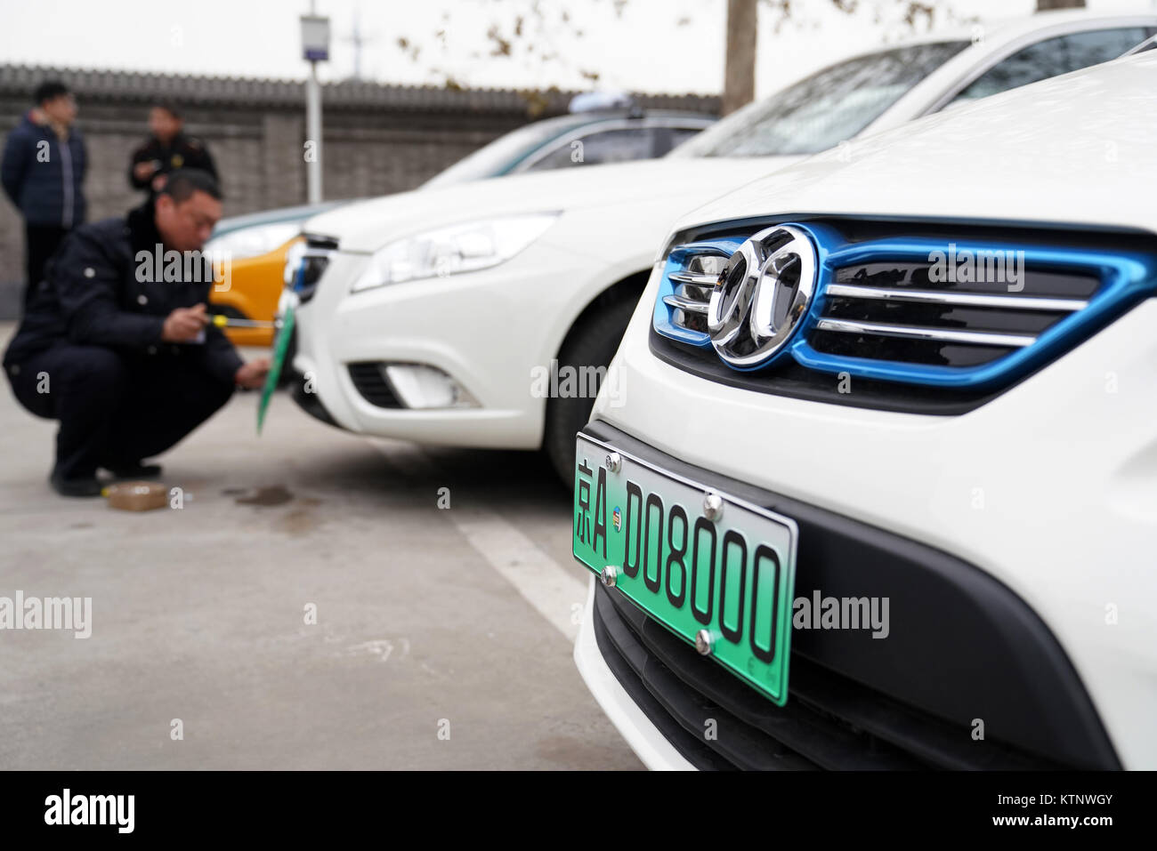 Beijing, China. 28th Dec, 2017. A new license plate is installed on a ...
